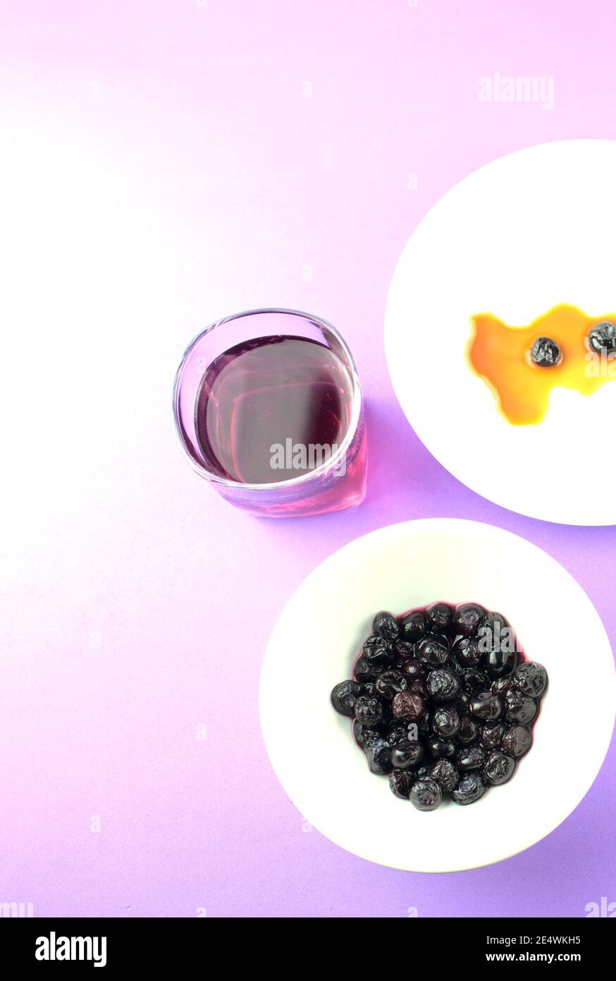 Blueberries, pulp in syrup. Blueberry juice on purple background. Food ...