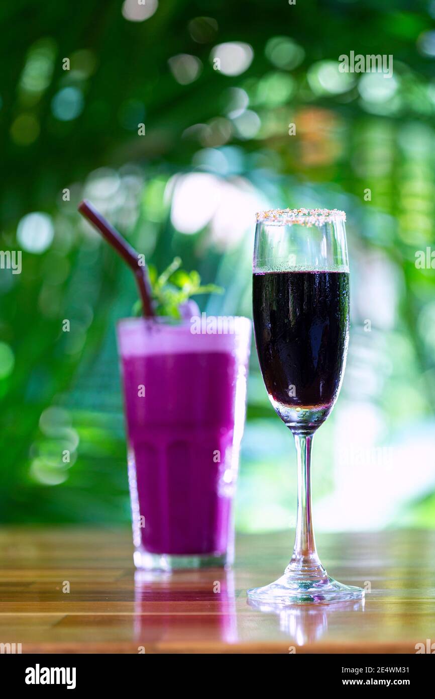 Mulberry juice is freshly squeezed in glass. on the wood table with ...