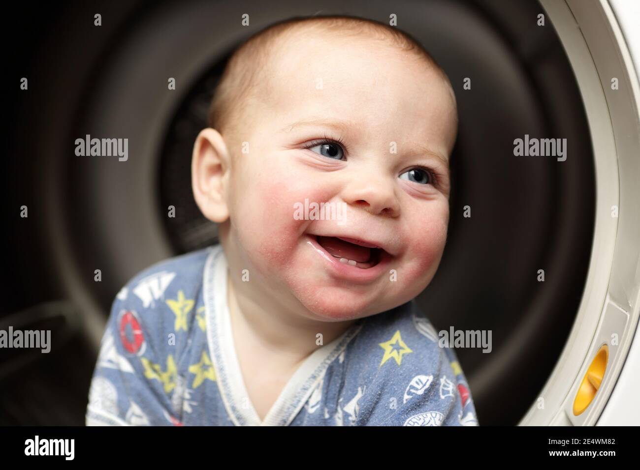 Portrait of a smiling baby in the dryer Stock Photo - Alamy