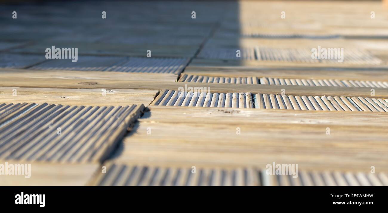 Closeup of wooden, checkered pattern in dark and light brown colors ...