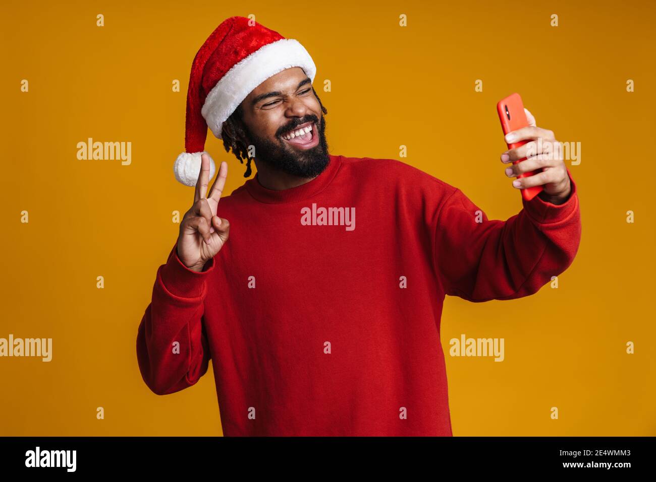 Happy african american guy gesturing peace sign while taking selfie on ...