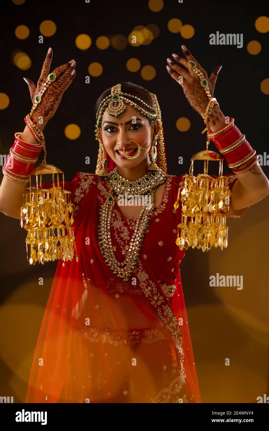 Indian Bride raising her hands showing her Jewellery Stock Photo - Alamy