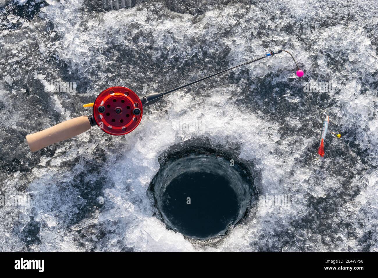 Winter fishing rod by the hole in the ice 2 Stock Photo - Alamy