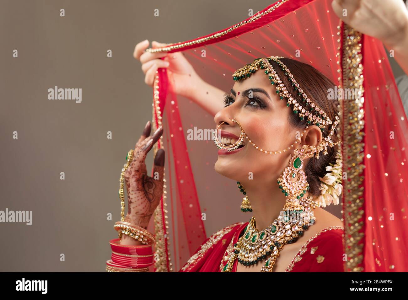 Veil being put on an Indian bride Stock Photo - Alamy