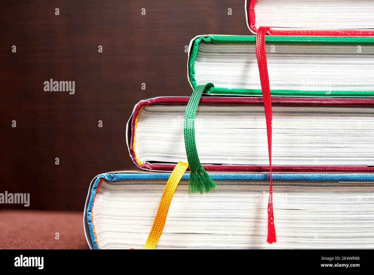 Pile of colorful books on the bookshelf. Bookshop and library ...