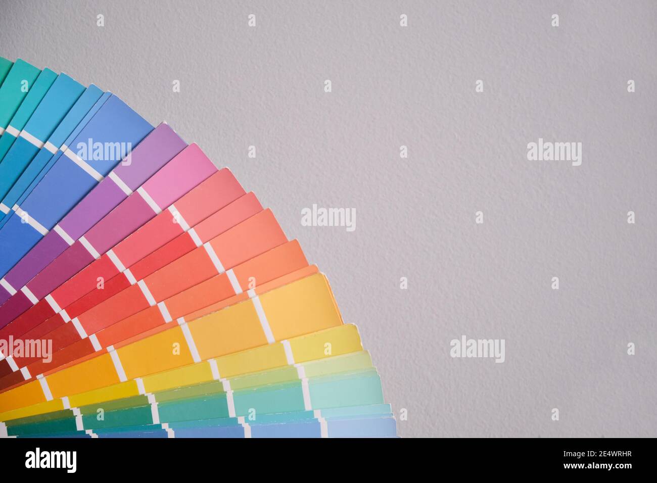 Old color palette guide catalogue on a gray wall. House painter tool ...