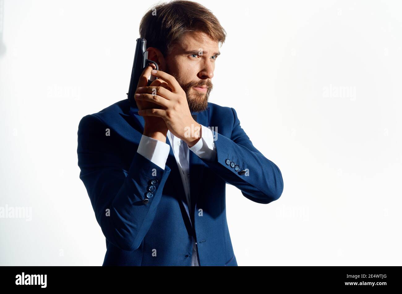 business man in a suit with a gun in his hands detective caution crime ...