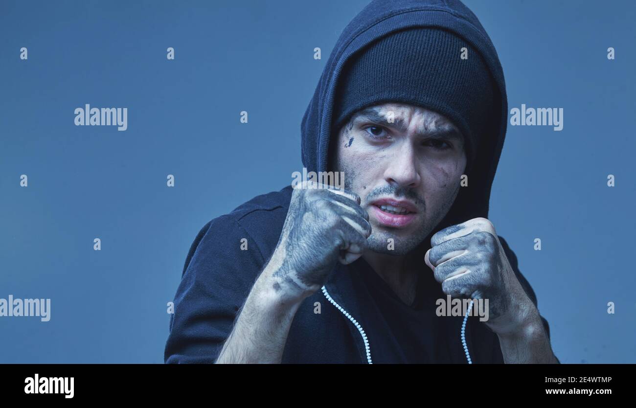 Portrait of robber giving a punch and ready to robbery the money ...