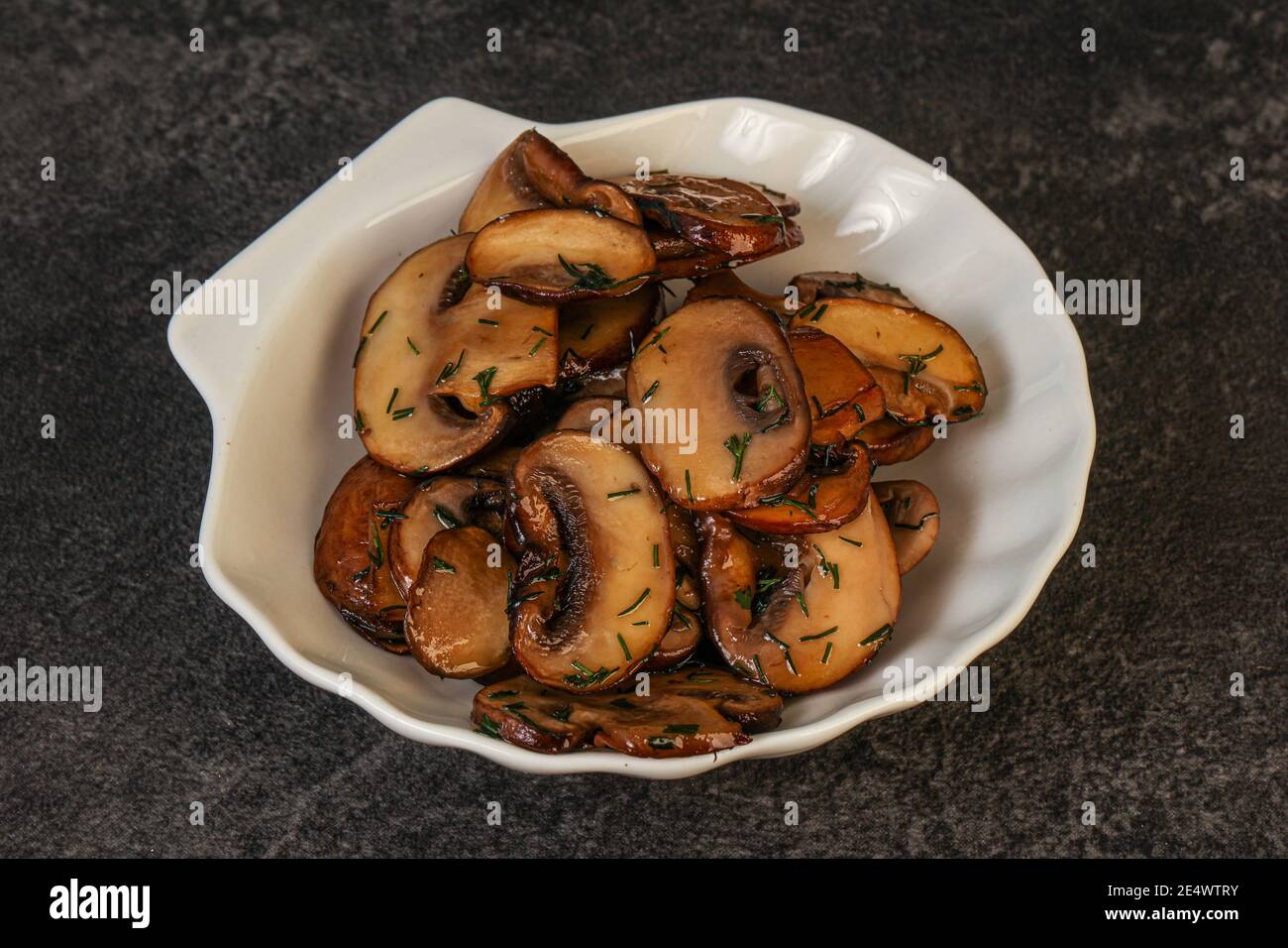 Roasted champignon with herbs and spices in the bowl Stock Photo - Alamy