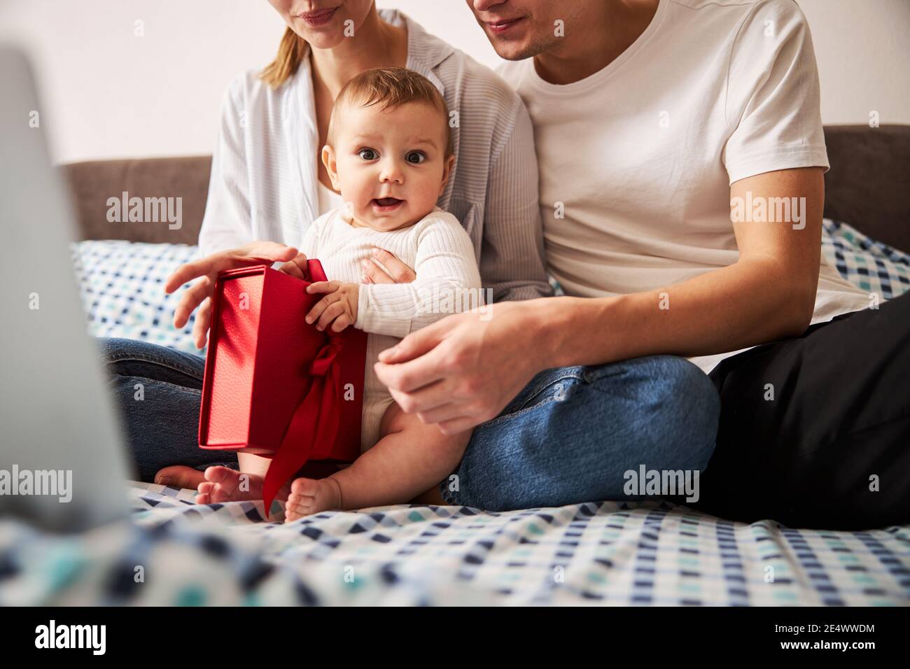 Positive delighted little kid holding gift box Stock Photo - Alamy