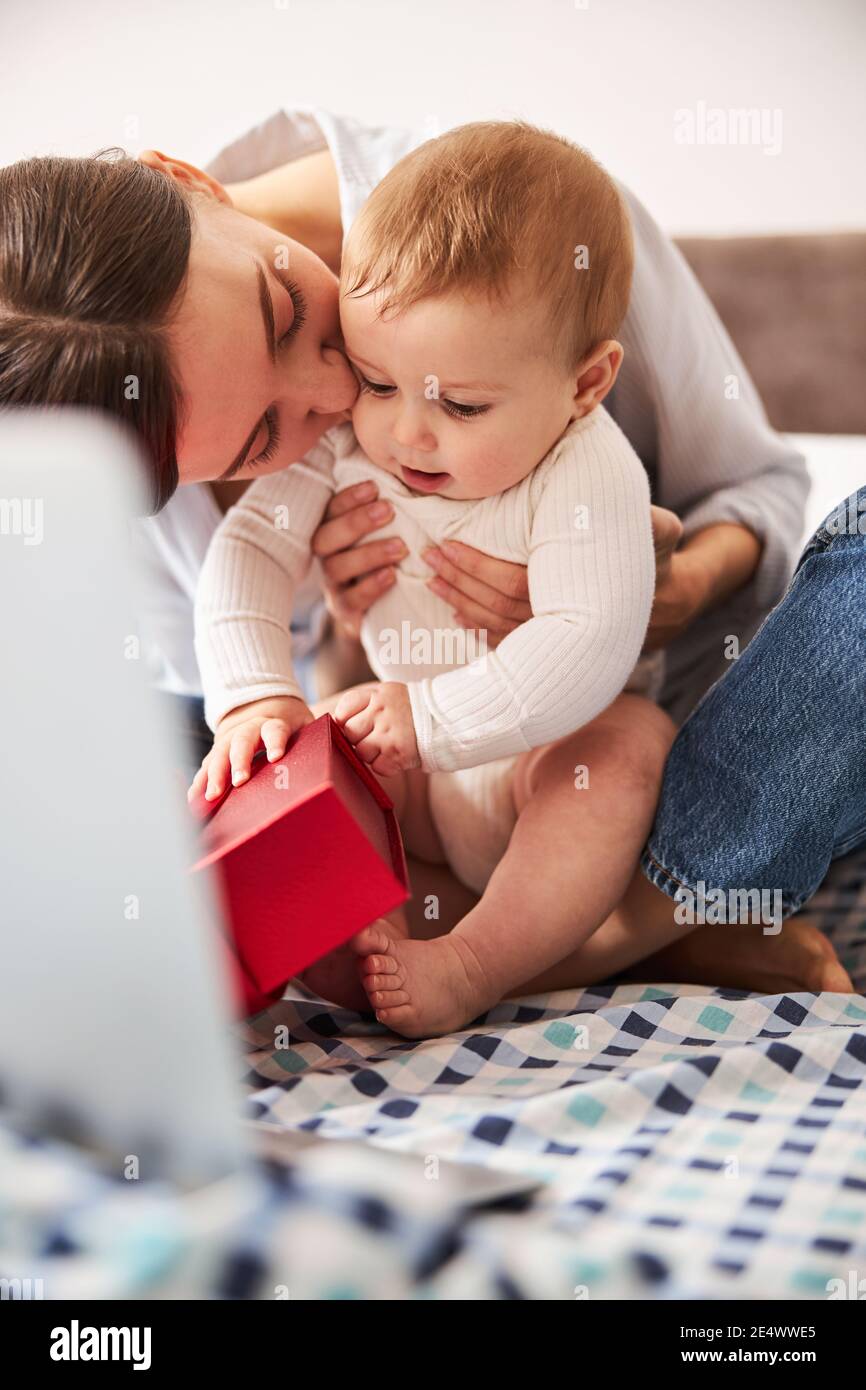 Close up of kind woman kissing her baby Stock Photo - Alamy