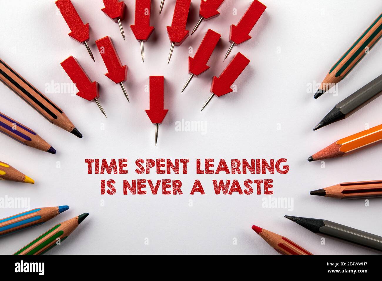 Time spent learning is never a waste. Red arrows and colored pencils on ...
