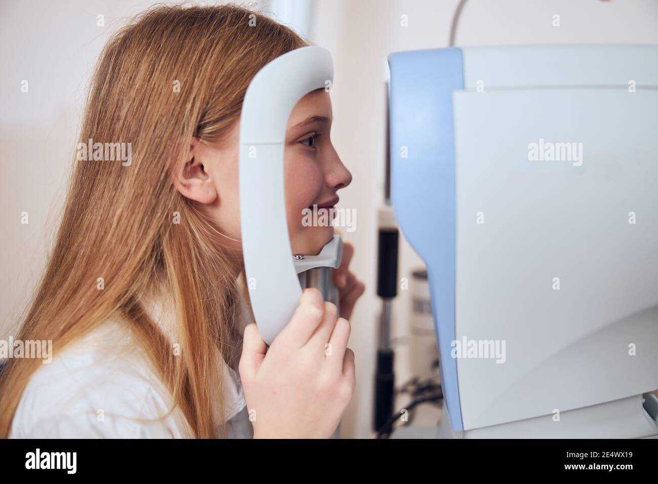 Elegant teenager girl checking eyesight in ophthalmology clinic Stock ...