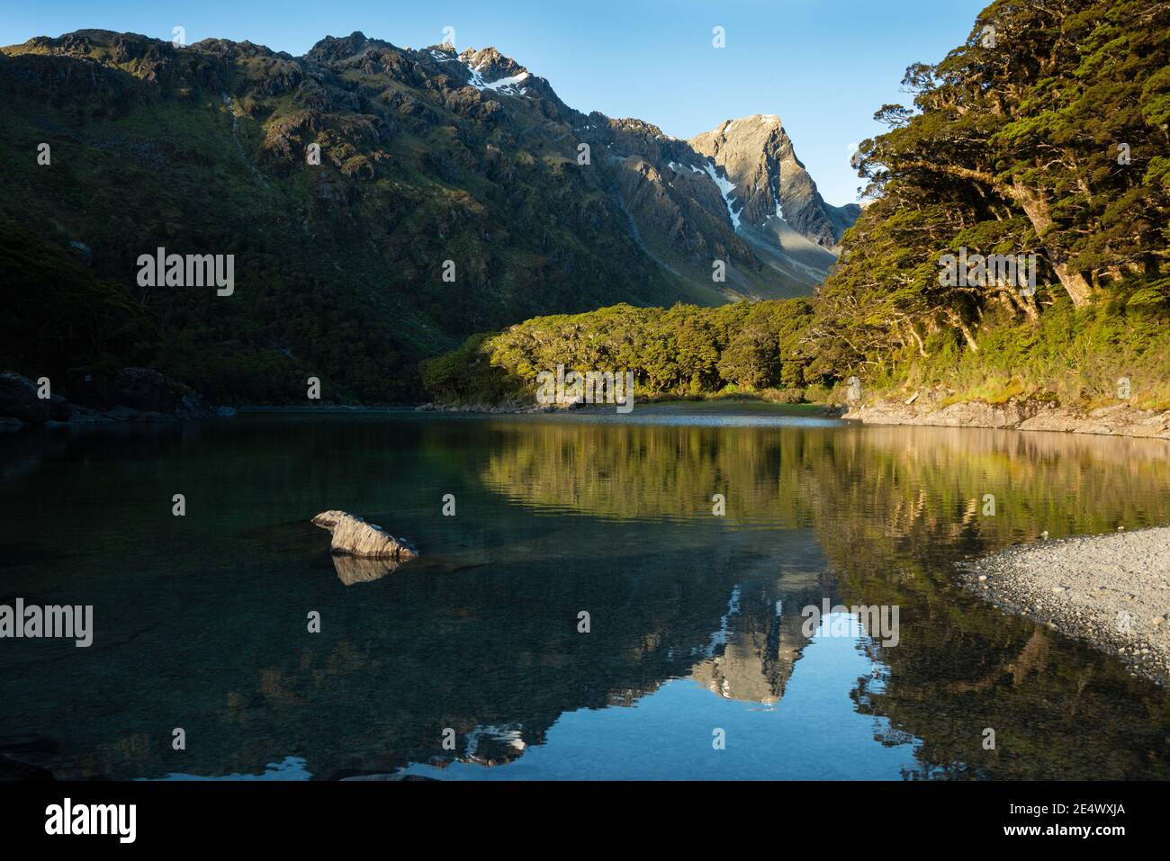 Mountains reflected in the clear waters of Lake Mackenzie, Routeburn ...