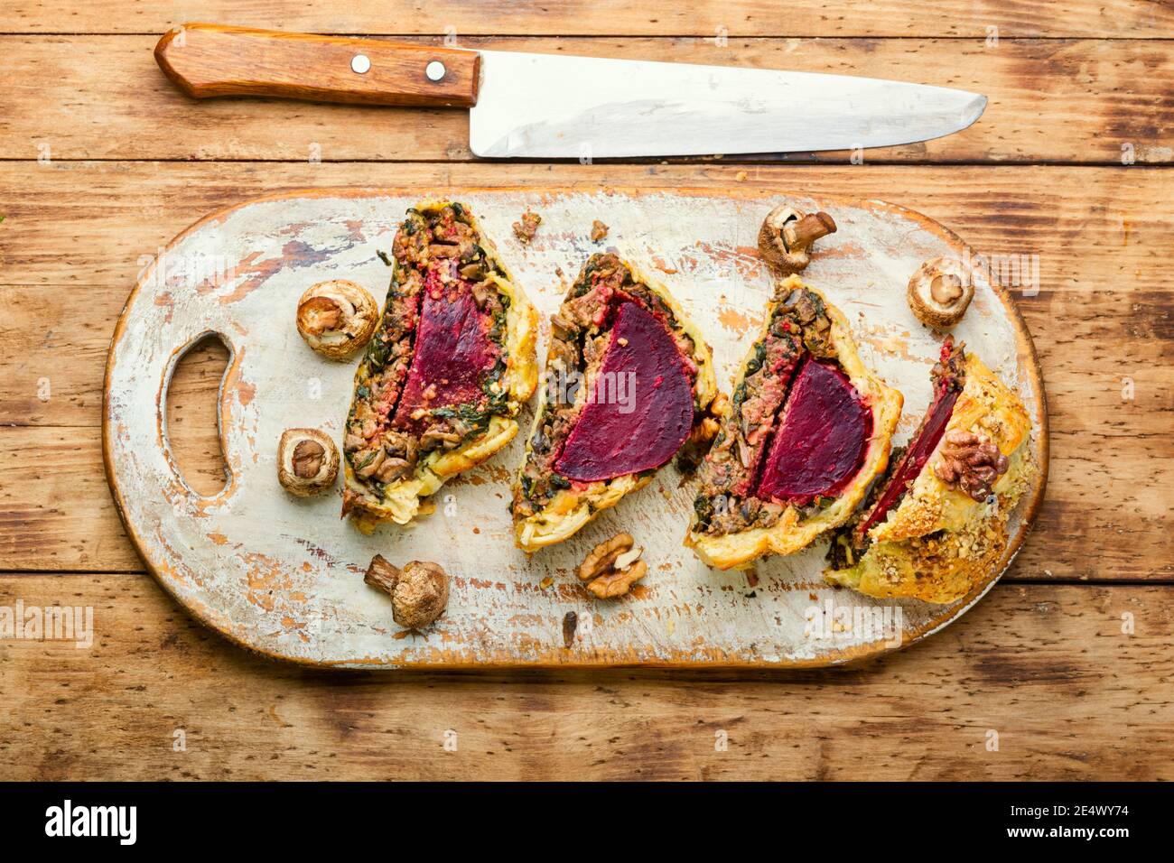 Delicious beetroot pie sliced on a kitchen board.Wellington pie Stock ...