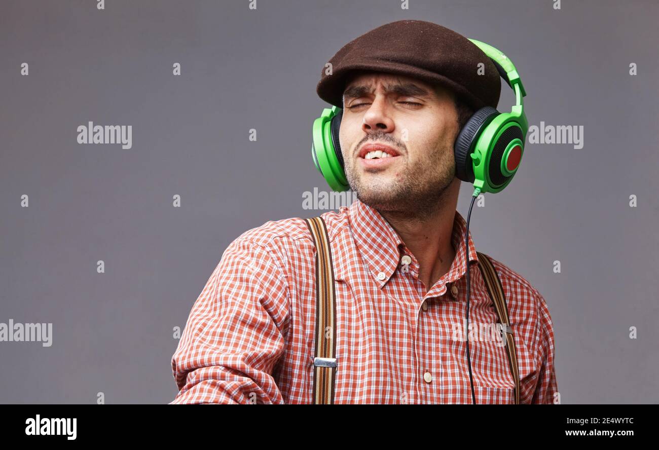 Retro music. Portrait of handsome male dj with closed eyes in ...