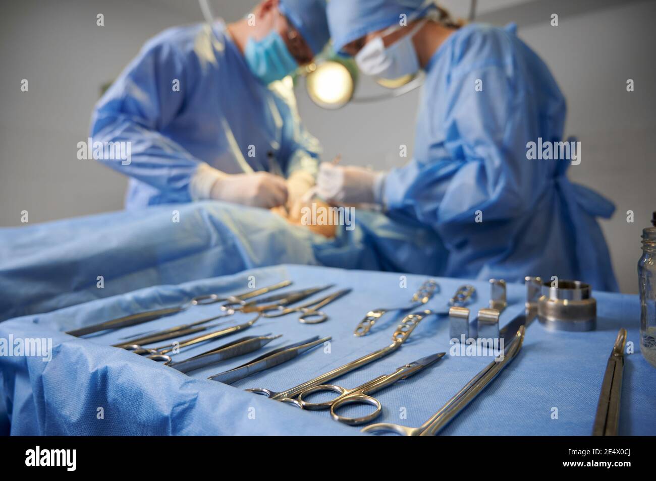 Plastic surgery instruments on surgical table with medical team and ...