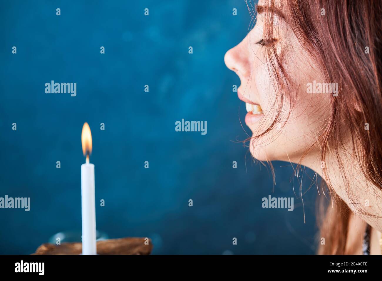 Woman blowing out candle hi-res stock photography and images - Alamy