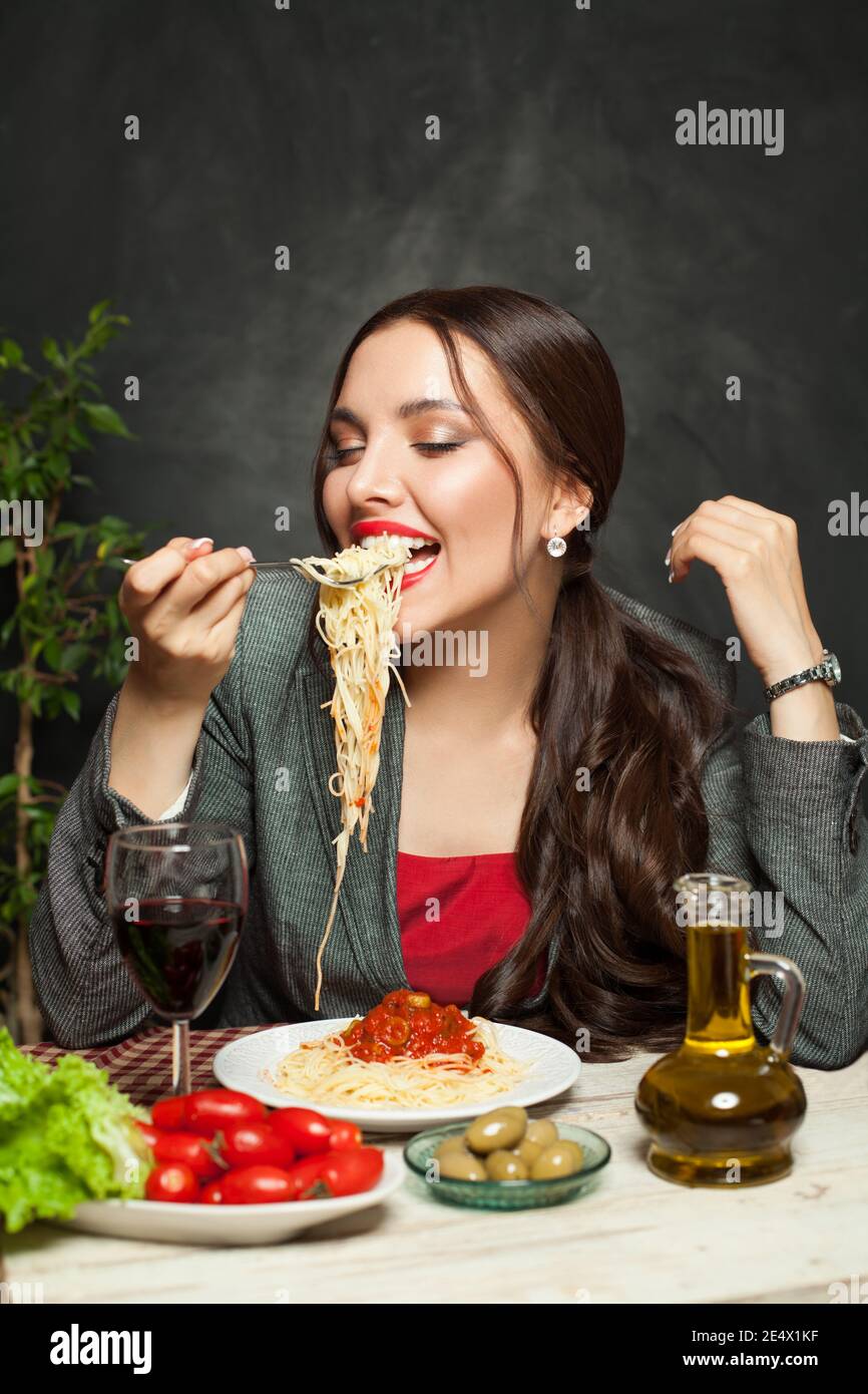 Pretty woman eating italian pasta in restaurant Stock Photo - Alamy