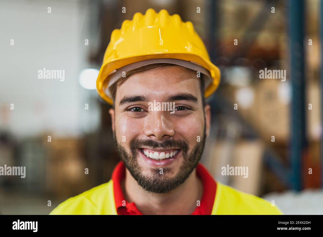 Portrait of happy young man working in delivery warehouse - Logistic ...