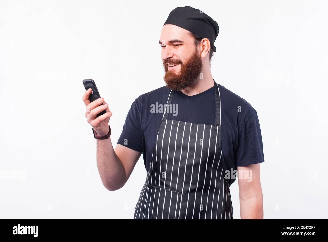 Photo of happy chef man using phone over white background Stock Photo ...