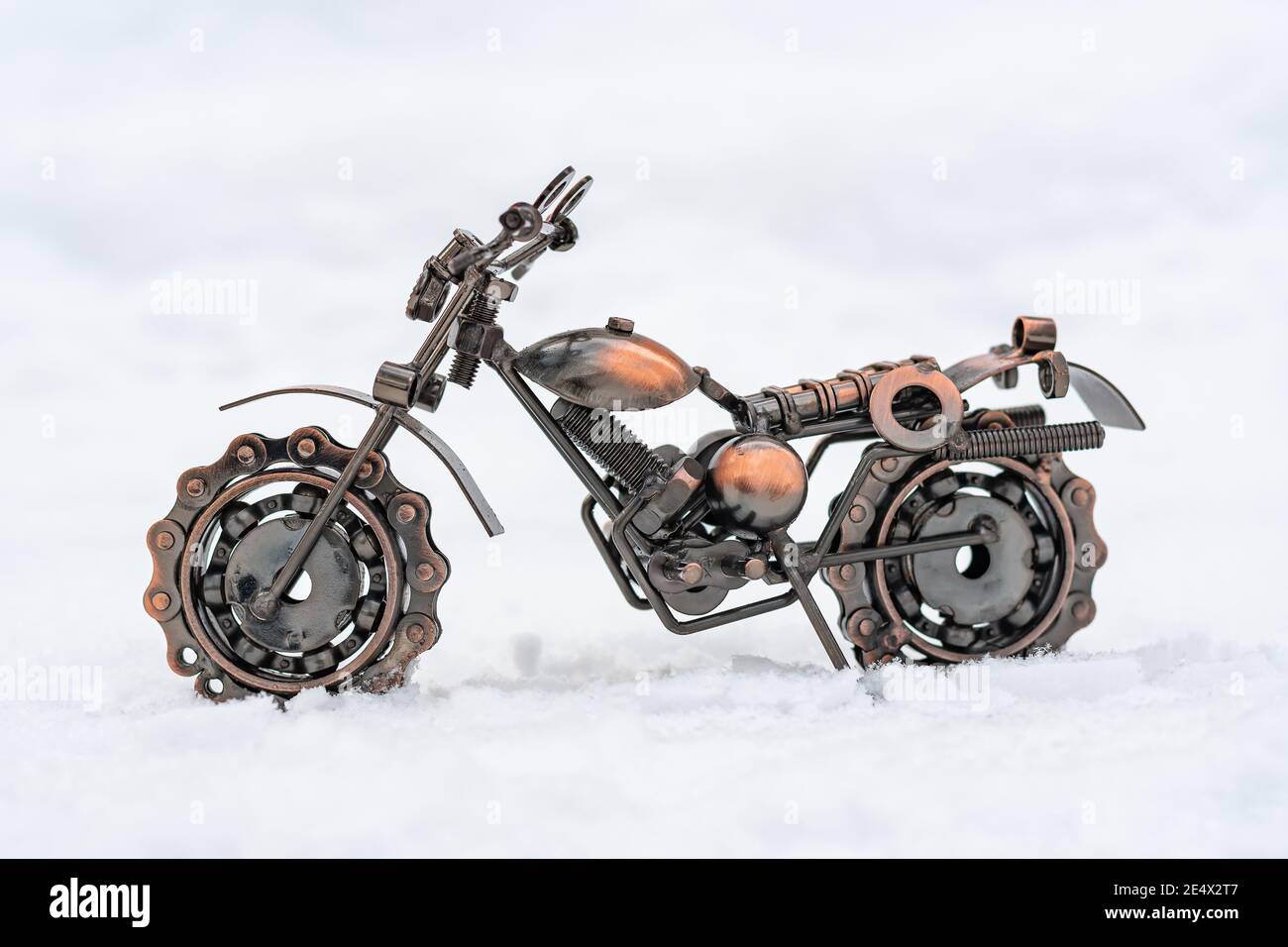Bronze metal model of a sports motorcycle stands on a white background ...