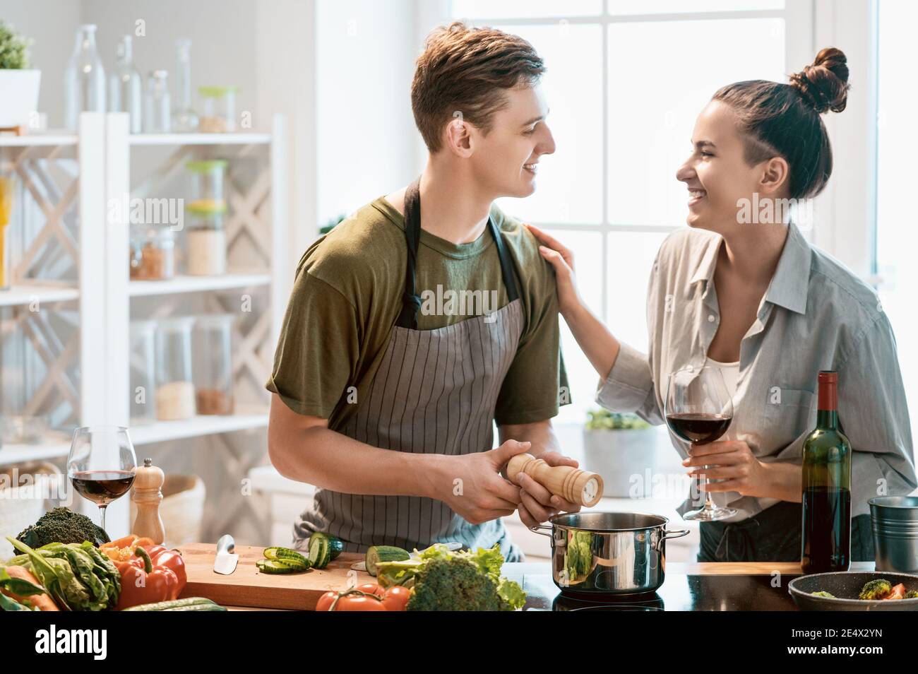 Healthy food at home. Happy loving couple is preparing the proper meal ...