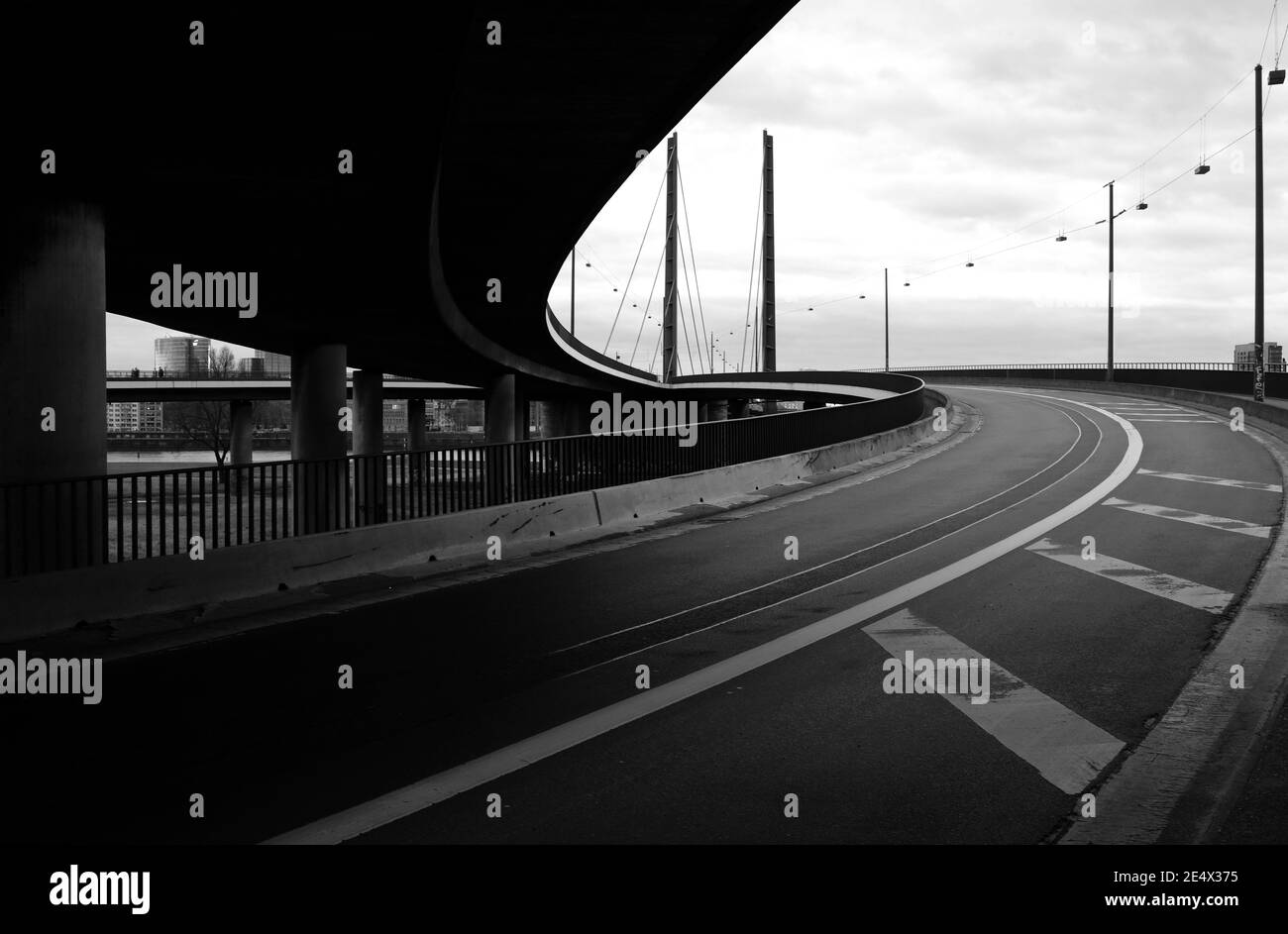 Monochrome photo of a curved road leading up to a bridge Stock Photo ...