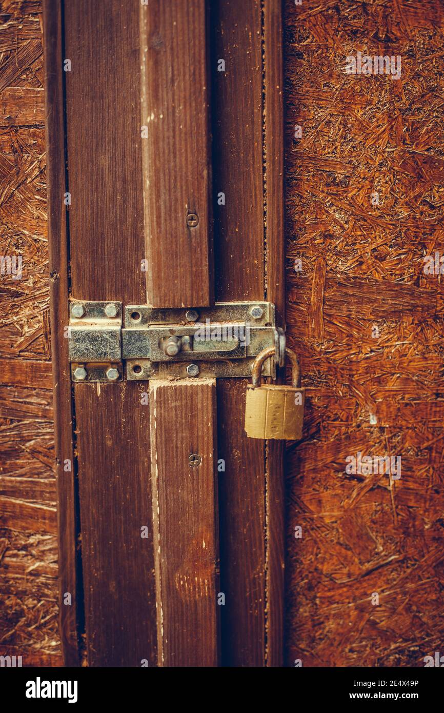 Close up shot of a latch and a padlock on a door Stock Photo - Alamy