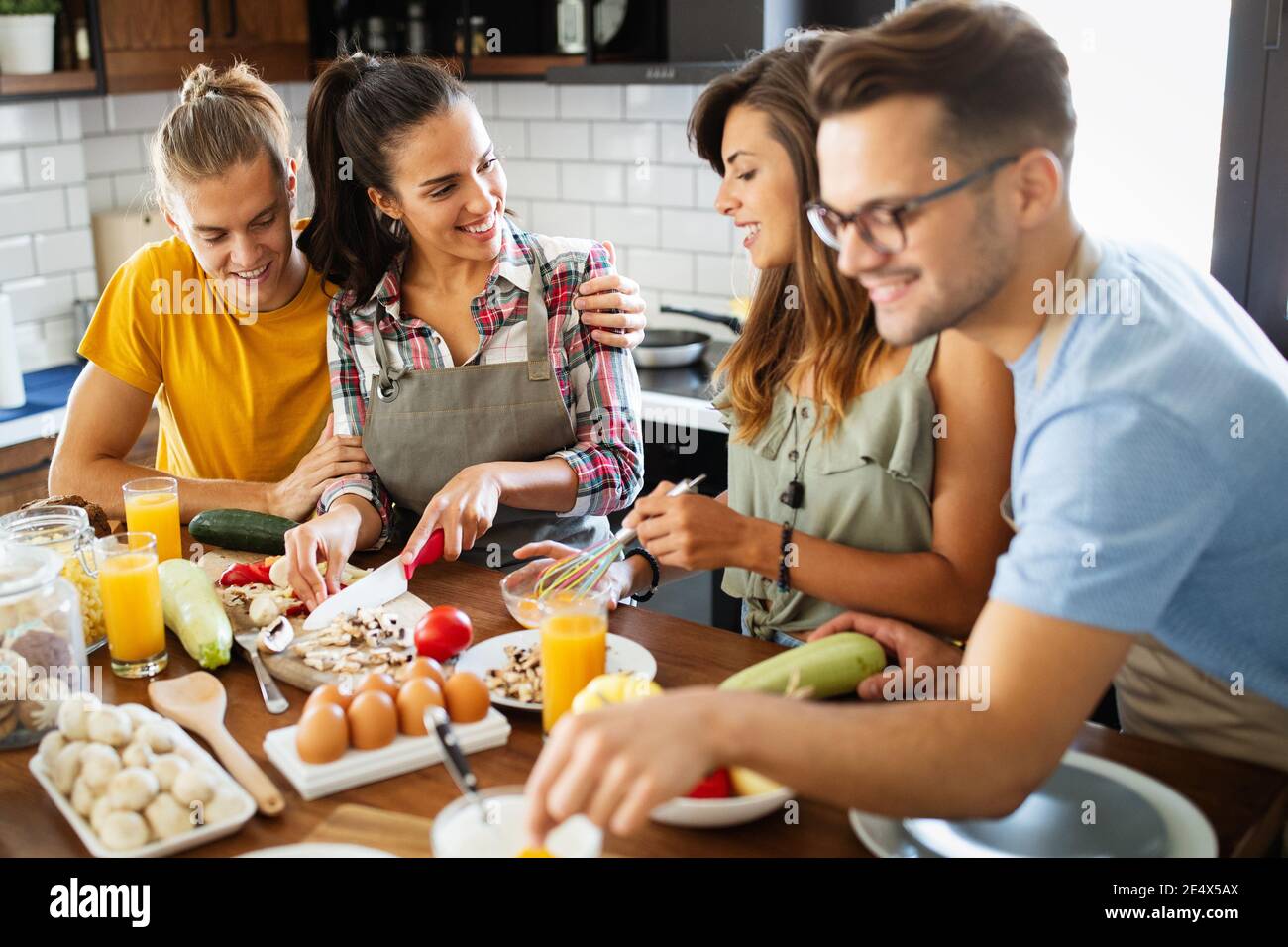 Beautiful happy people, friends is smiling while cooking together in ...