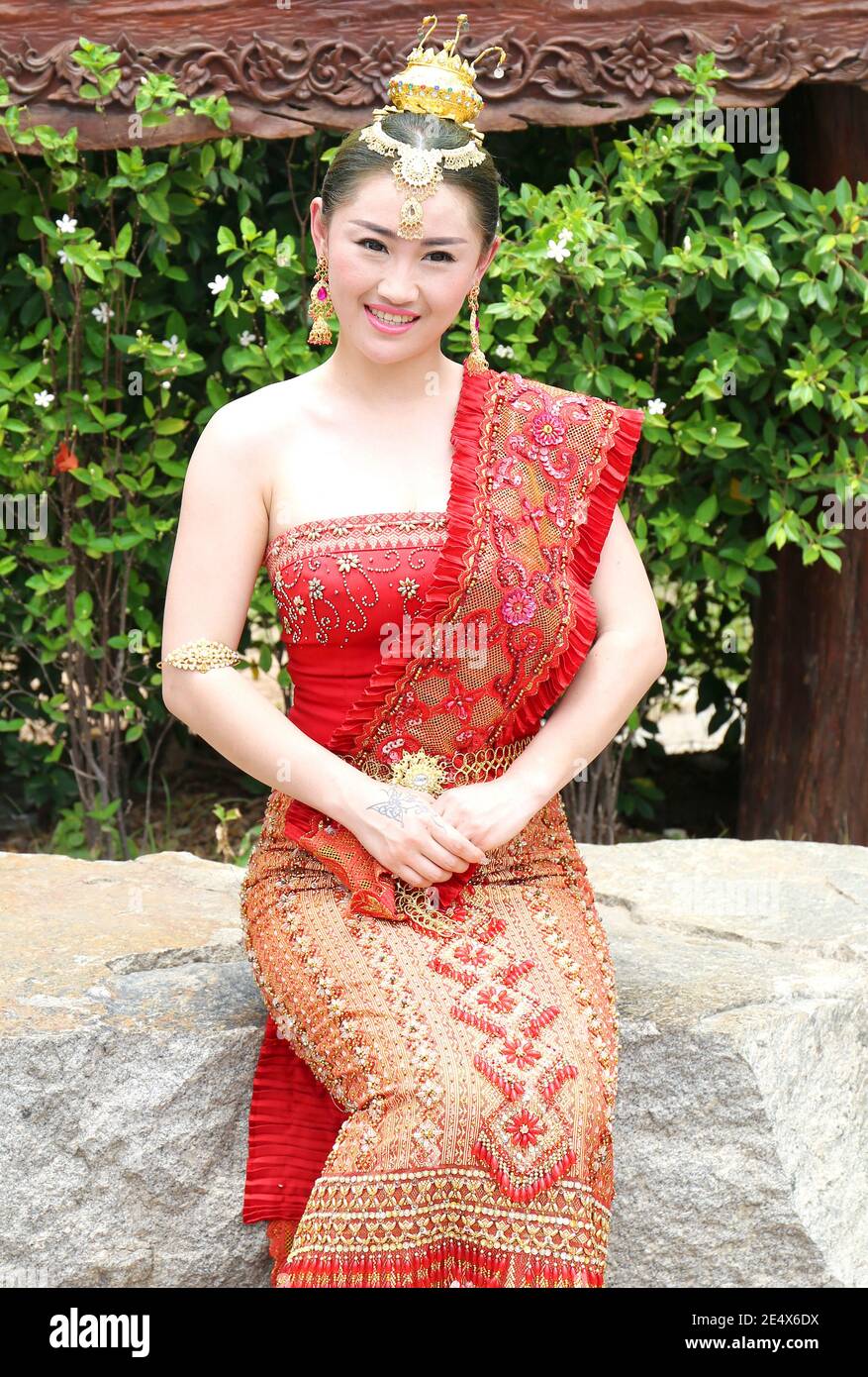 PHUKET,THAILAND-APRIL 7:Young Thai Girl in traditional outfit sitting and posing at Chalong ...