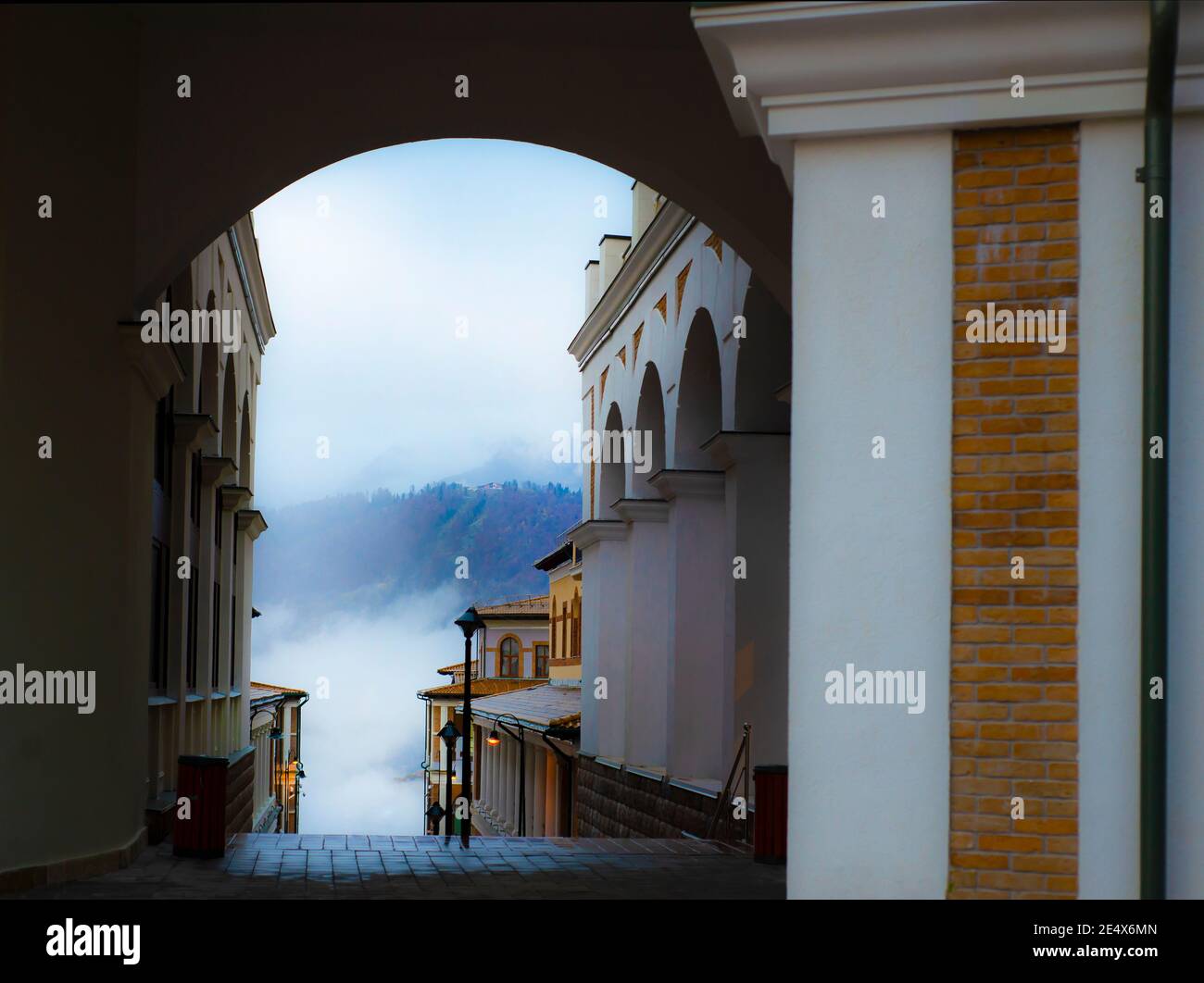 European architecture with an arch. In the arch there is a blue sky and ...