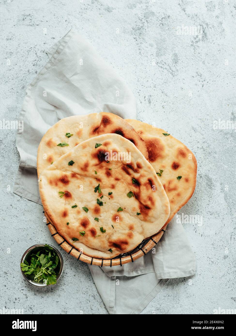 Fresh naan bread on gray cement background with copy space. Top view of ...