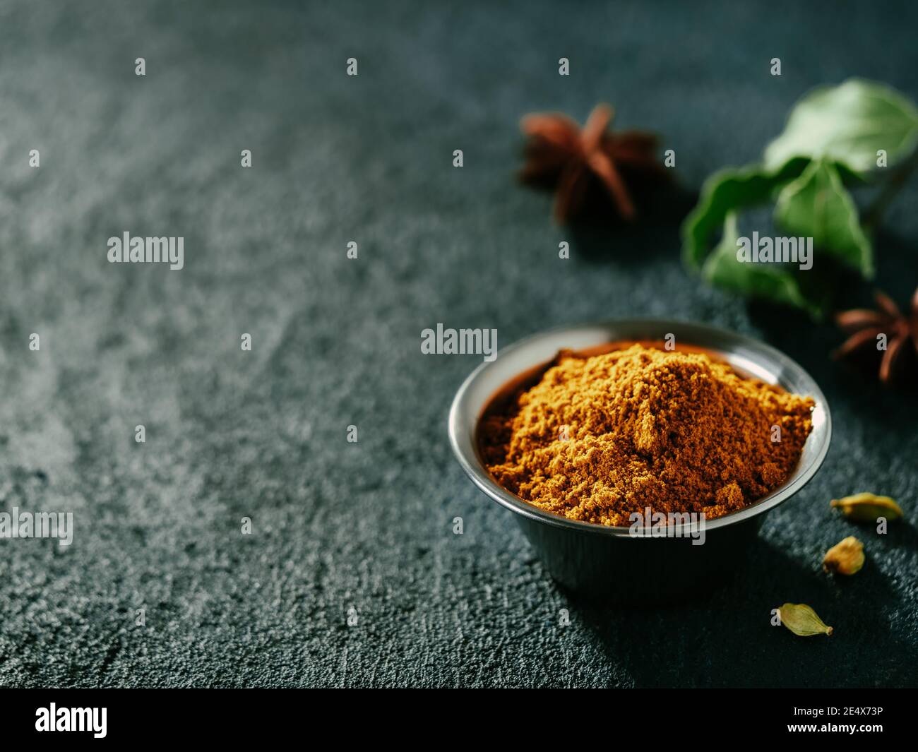 Indian or pakistani masala powder and spices on dark textured ...