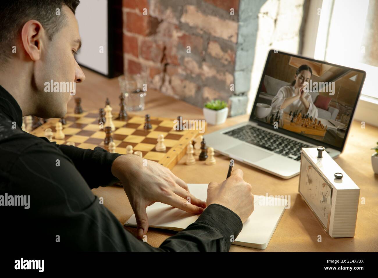 Serious Caucasian man chess player playing chess online with his ...