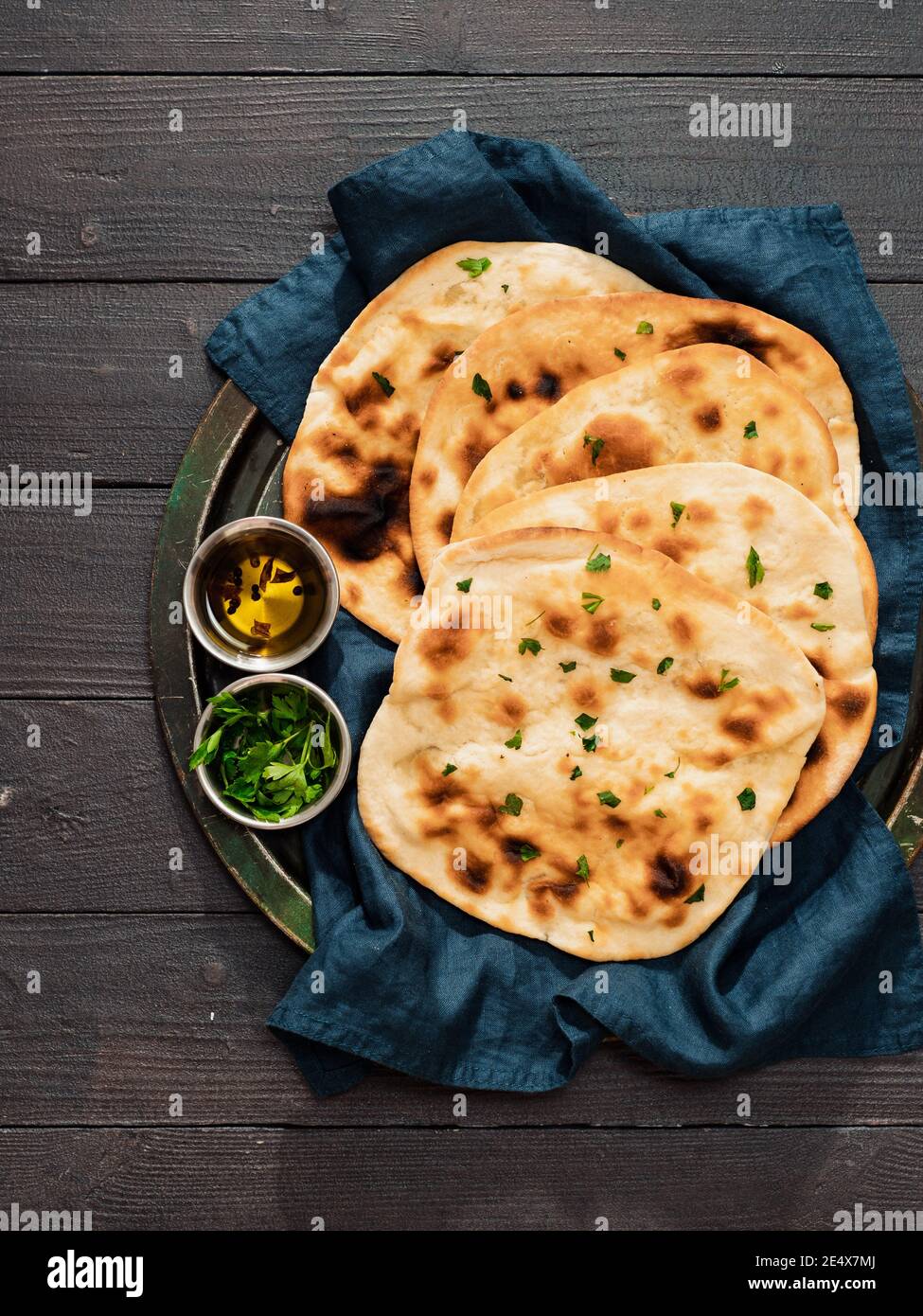 Fresh naan bread on dark wooden background with copy space. Several ...