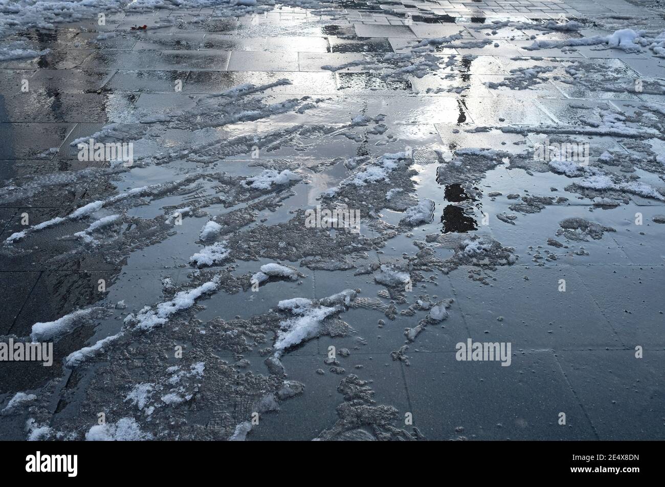 Foot prints in melting snow on the ground in a pedestrian zone Stock ...