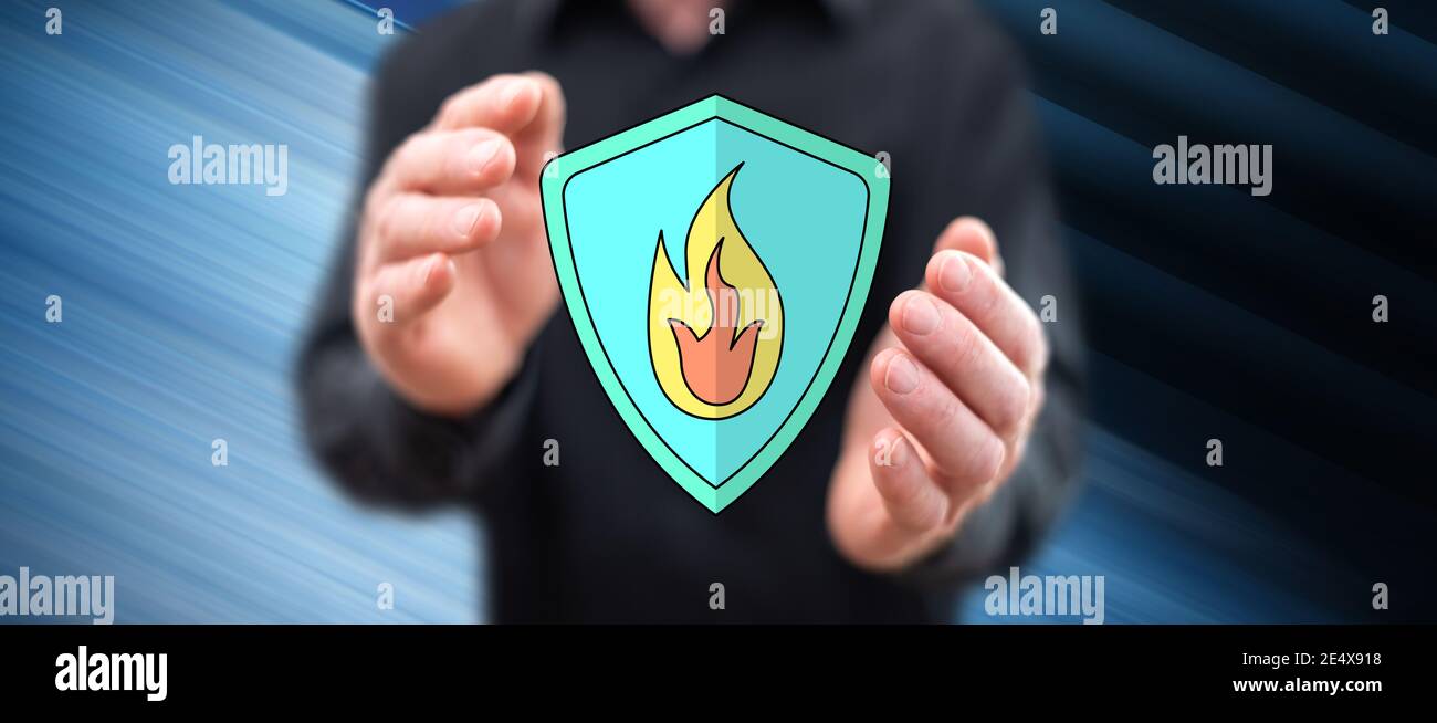 Fire protection concept between hands of a man in background Stock ...