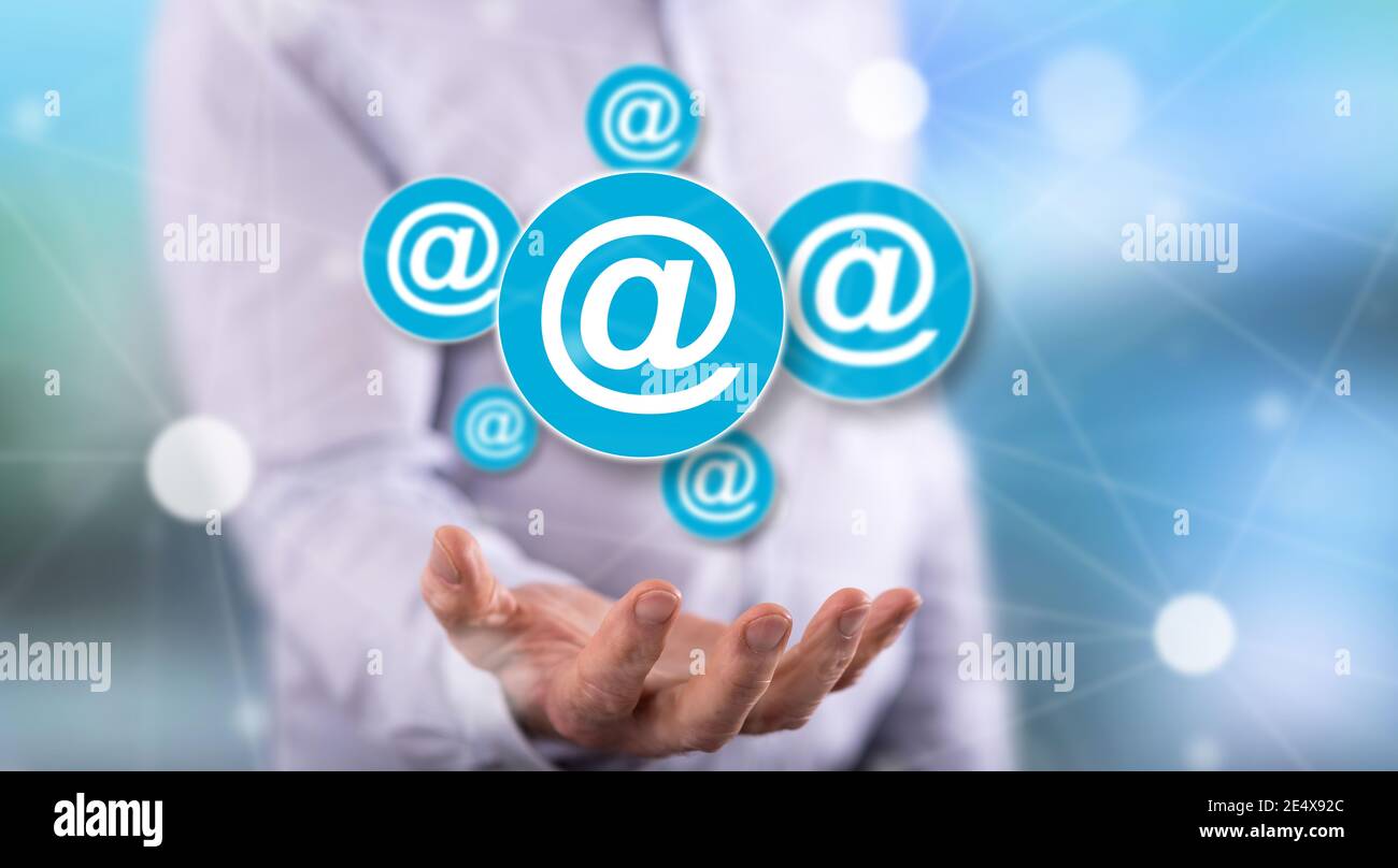 Email concept above the hand of a man in background Stock Photo - Alamy