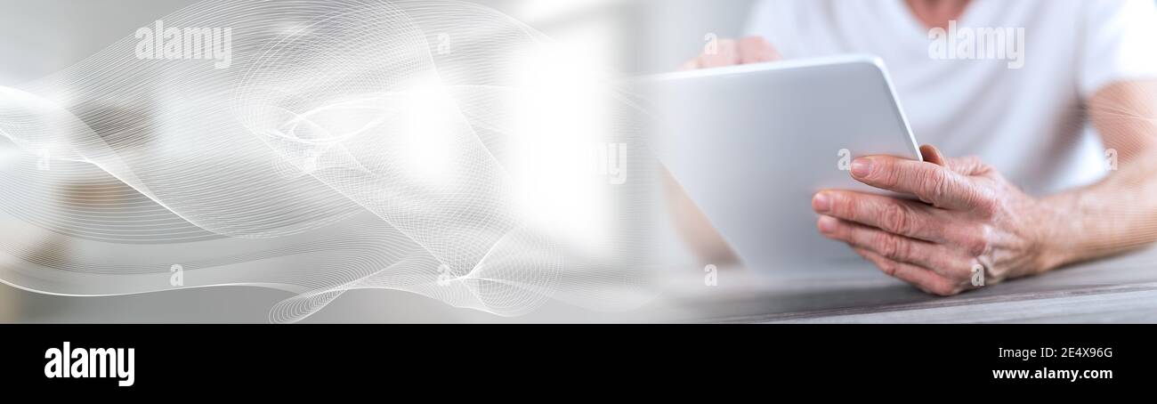 Man sitting using a tablet; panoramic banner Stock Photo - Alamy