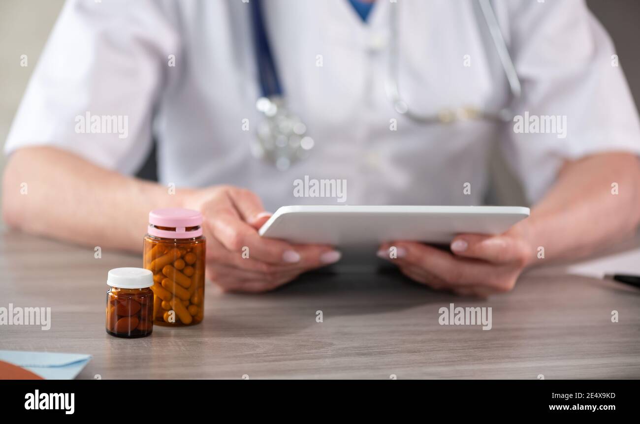 Female doctor using digital tablet at workplace Stock Photo - Alamy