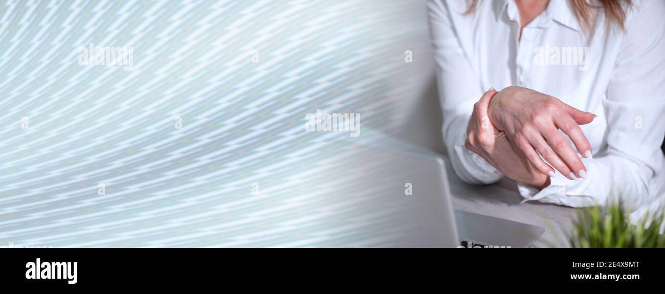 Businesswoman suffering from wrist pain; panoramic banner Stock Photo ...