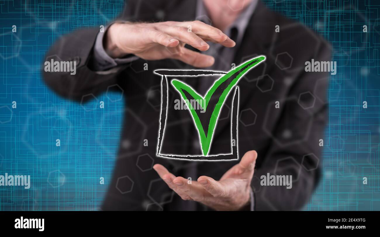 Validation concept between hands of a man in background Stock Photo - Alamy