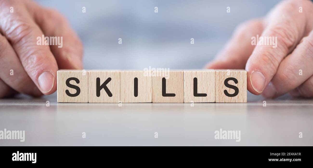 Word skills on wooden cubes Stock Photo - Alamy