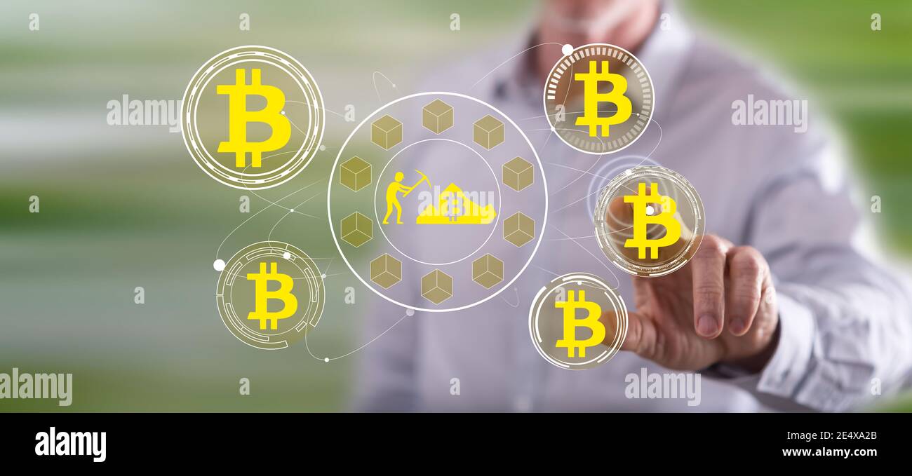 Man touching a bitcoin mining concept on a touch screen with his finger ...