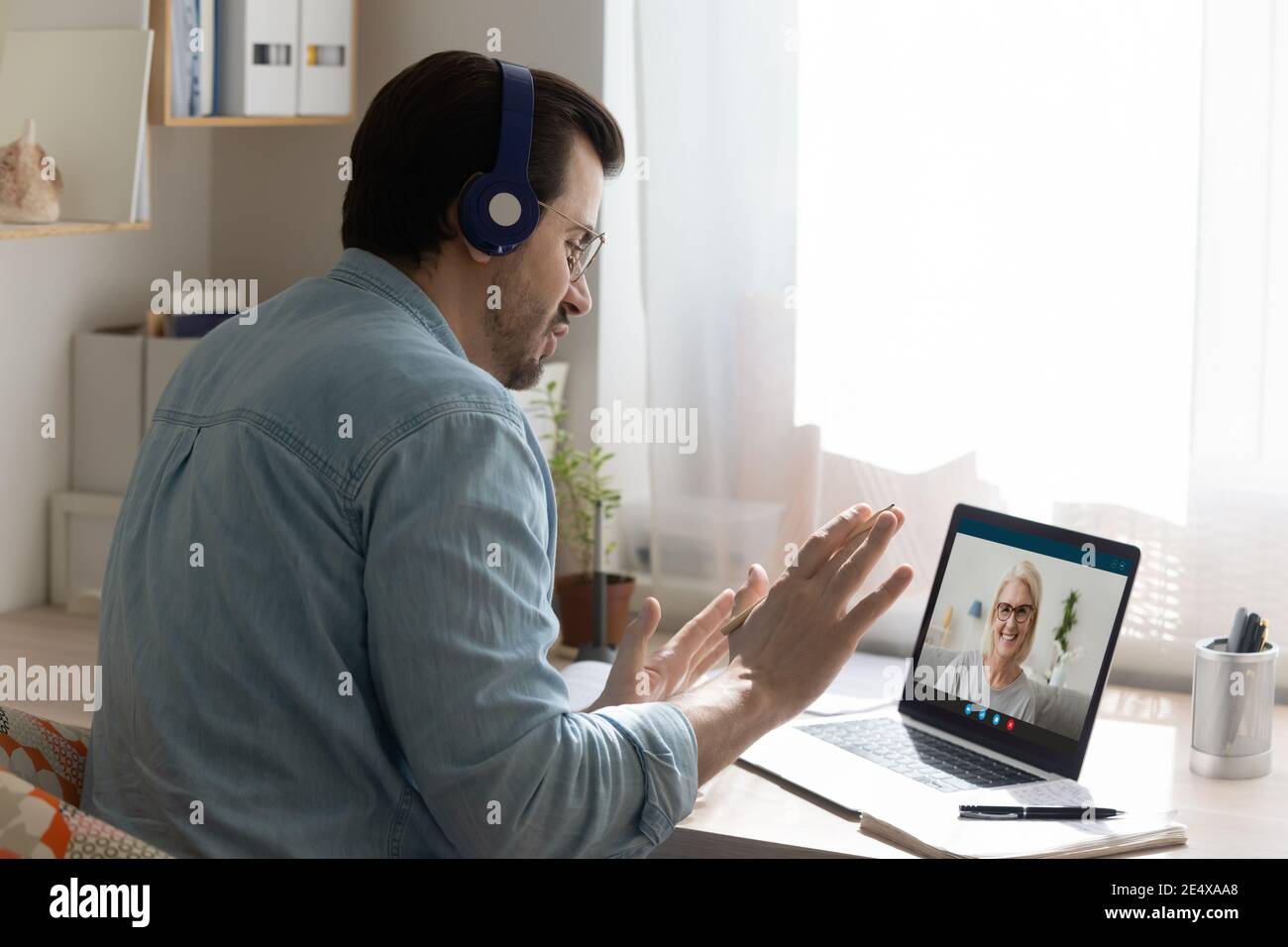 Focused young man remote student taking distant lesson via videocall ...