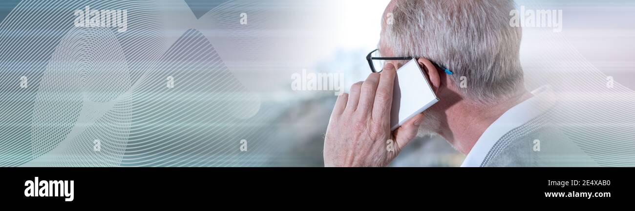 Senior businessman talking on mobile phone and looking through the ...