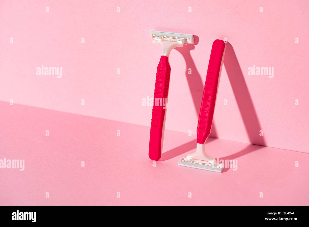 Pink disposable razors on pink background, copy space Stock Photo - Alamy