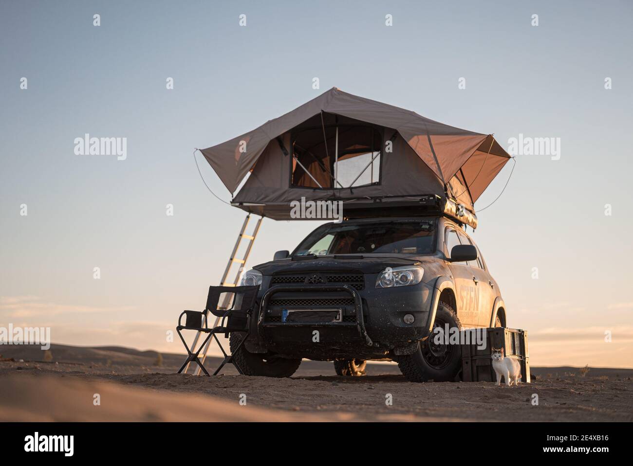Rooftop tent for camping on the roof rack of an off-road SUV car in a ...