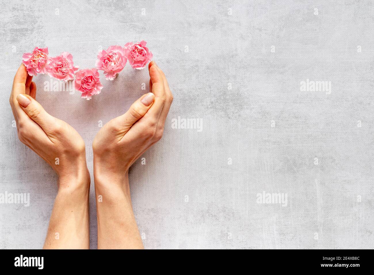 Heart shape of flowers with hands. Valentines Day, wedding or birthday ...
